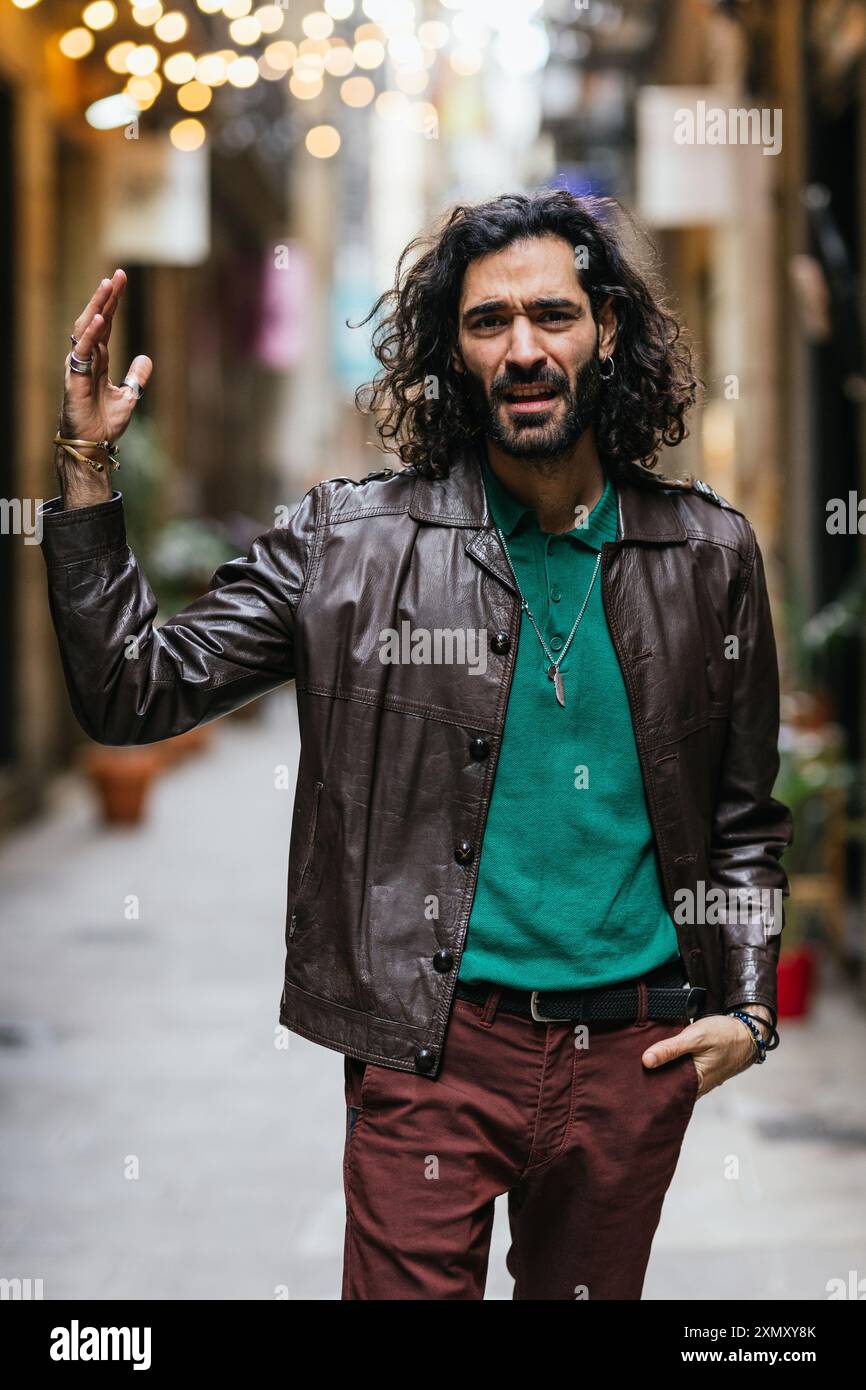 Angry man with long hair raising hand aggressively arguing in the ...