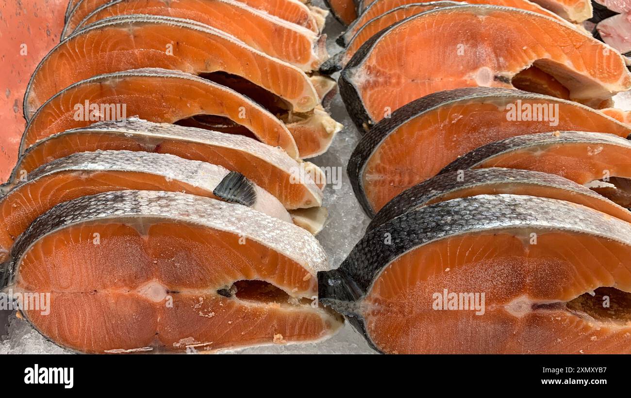 Side view of sliced salmon fish displayed in wet market Stock Photo - Alamy