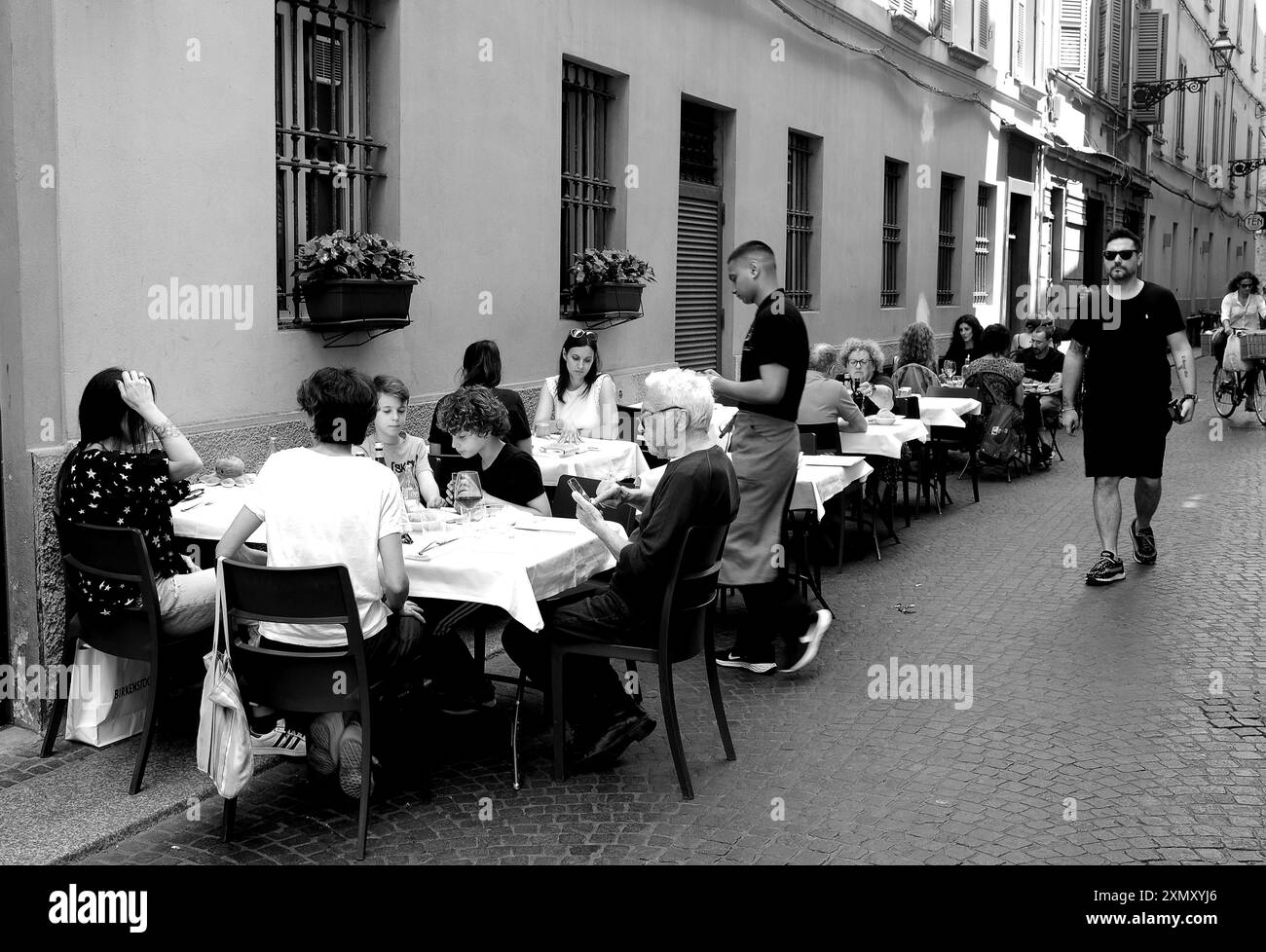 Restaurant waiter taking orders from diners at street tables in Parma ...