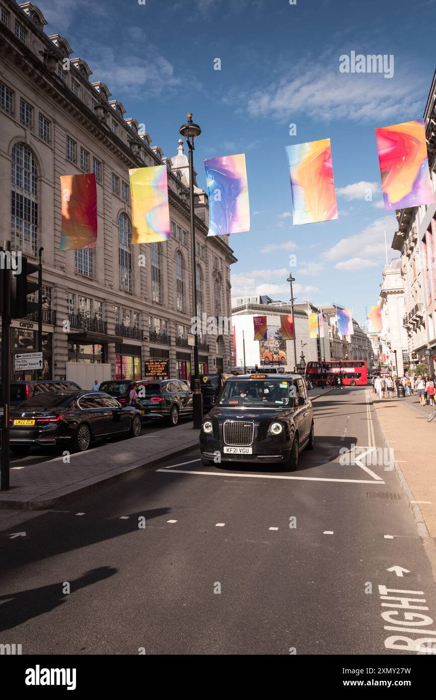 A London black cab waits underneath colourful Adham Faramawy's Rainbow ...