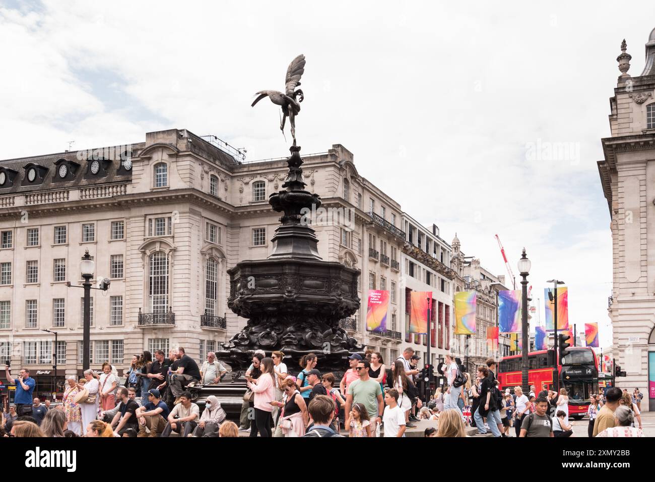 Crowds of tourists sitting around the Statue of Eros, PIccadilly Circus, London, England, UK ...