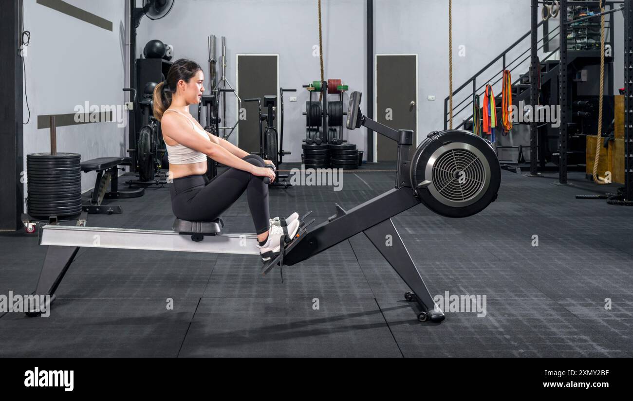 An athletic woman in sportswear is engaged in an intense workout ...