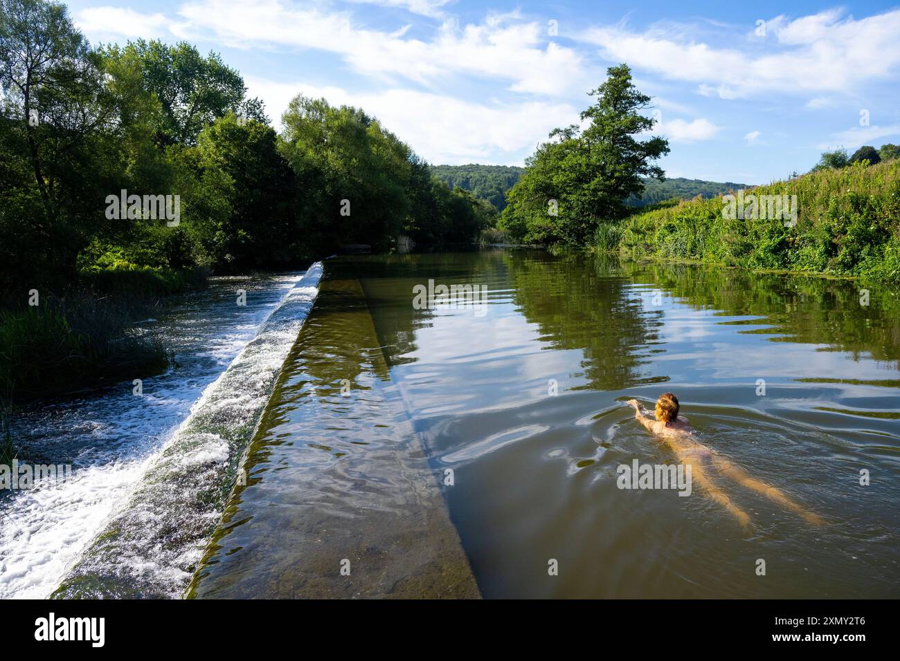 A woman enjoys the water at Warleigh Weir on the River Avon near Bath ...