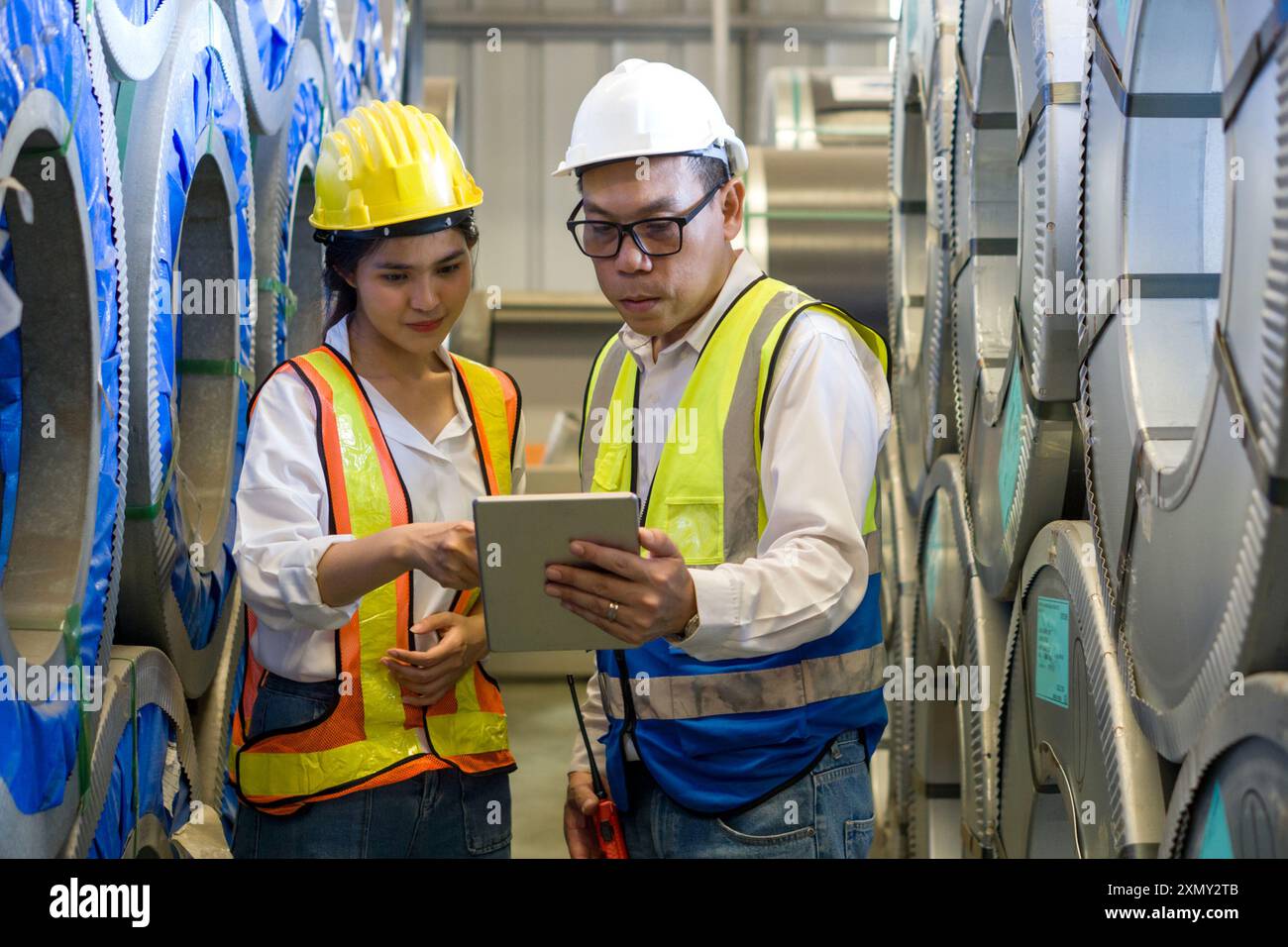 Senior engineer manager trains new employee within the metal sheet ...