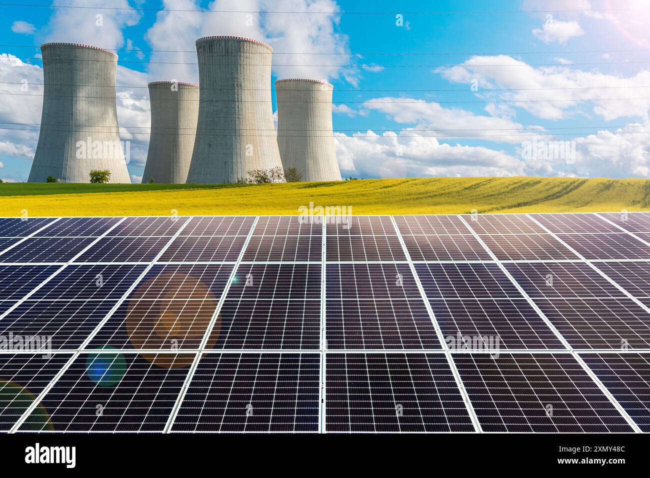 Solar panels with a nuclear power plant in the background. Comparison ...