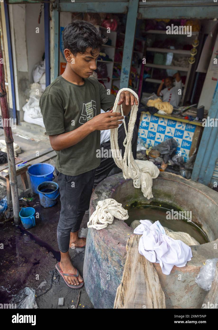 Bangladeshi young man dyeing fabrics, Dhaka Division, Rupganj ...