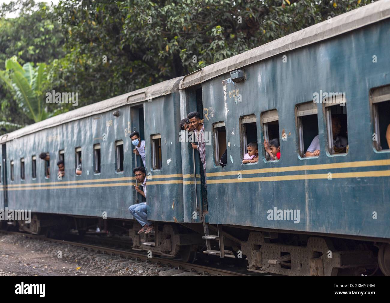 Passengers look out of a train carriage window, Chittagong Division ...