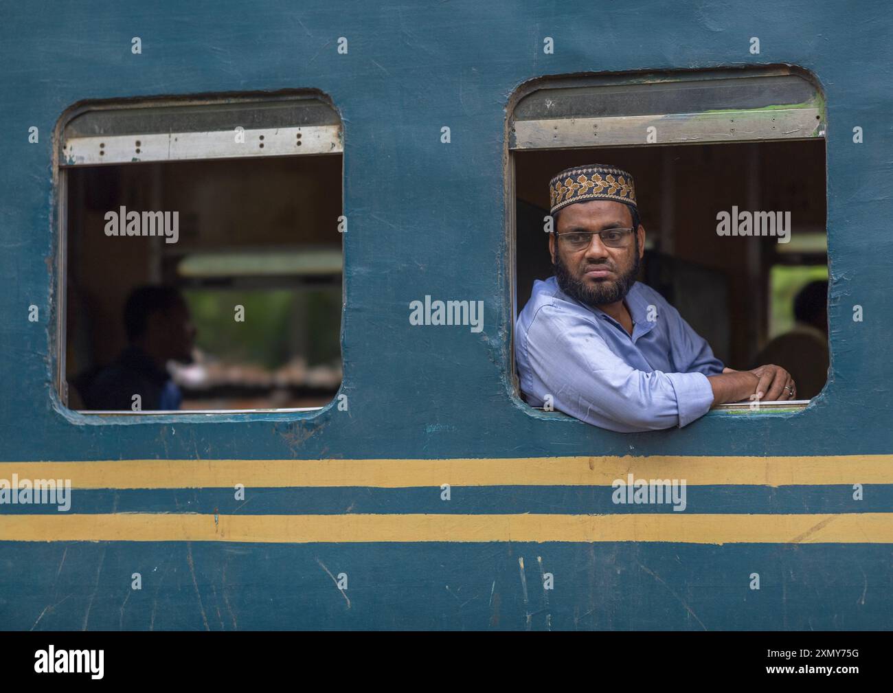 Passenger looks out of a train carriage window, Chittagong Division ...