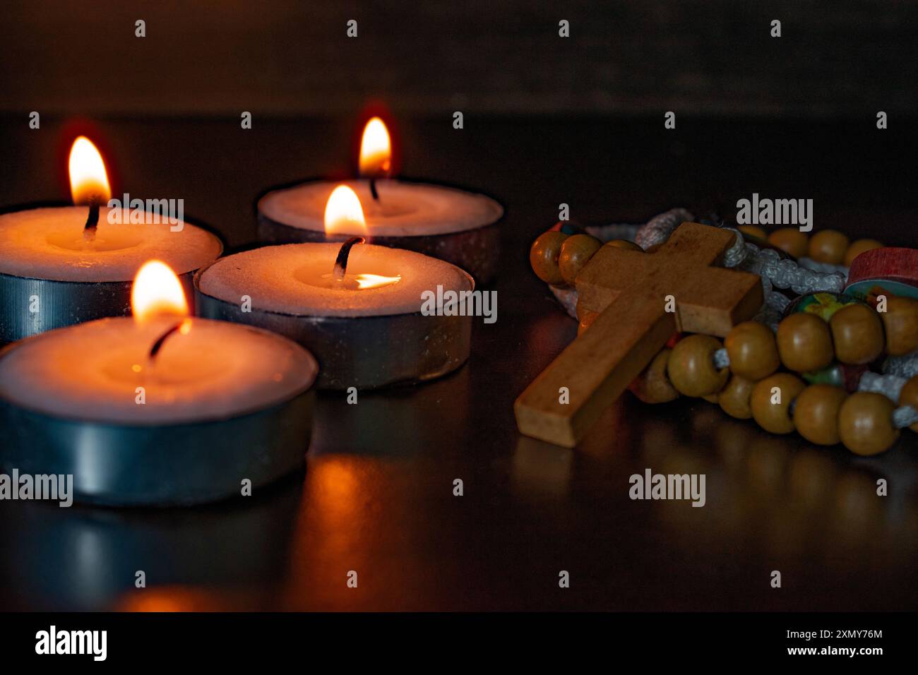 Candles with Holy Rosary on dark background. Christianity concept Stock ...