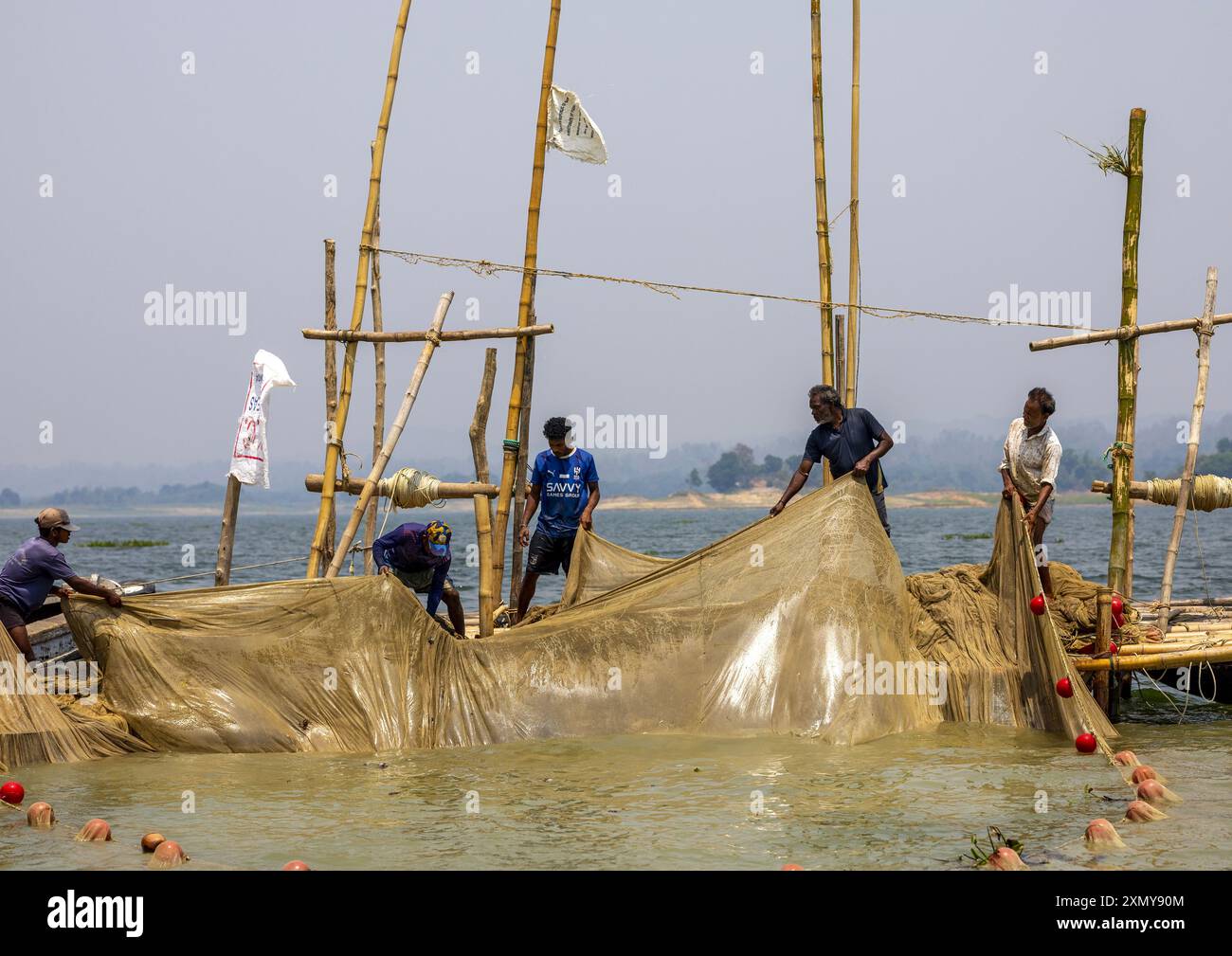 Bangladeshi fishermen pulling out fishing nets from Kaptai Lake ...
