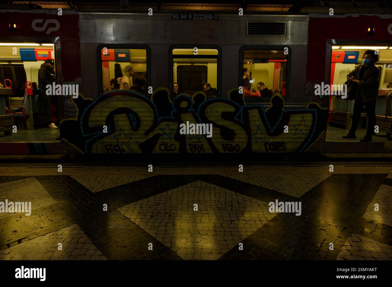 Passengers inside a graffiti-covered train at Rossio station Stock ...