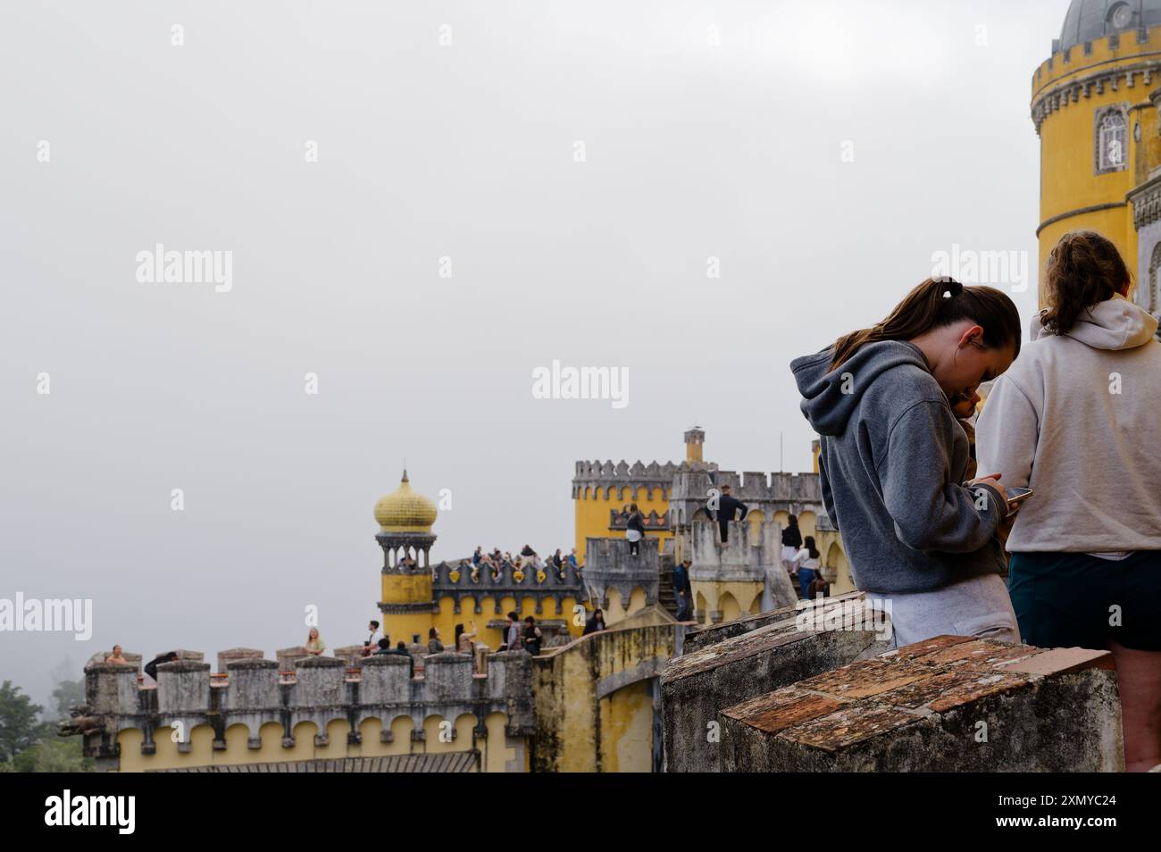 Visitor looking at her phone while exploring the vibrant yellow towers ...