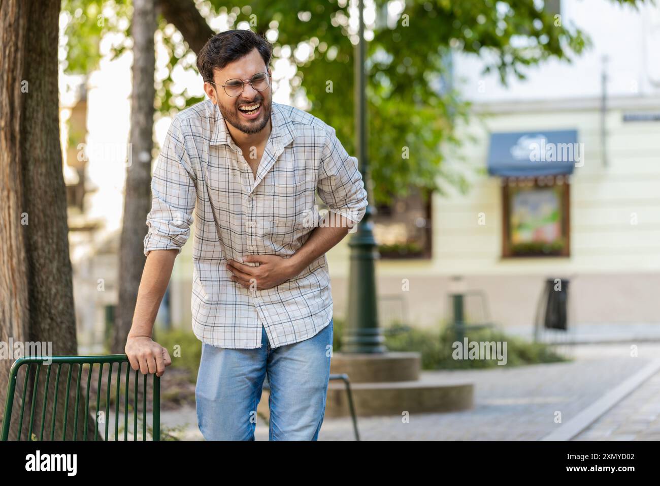 Arabian young man traveler feeling sudden strong abdominal stomach ache ...