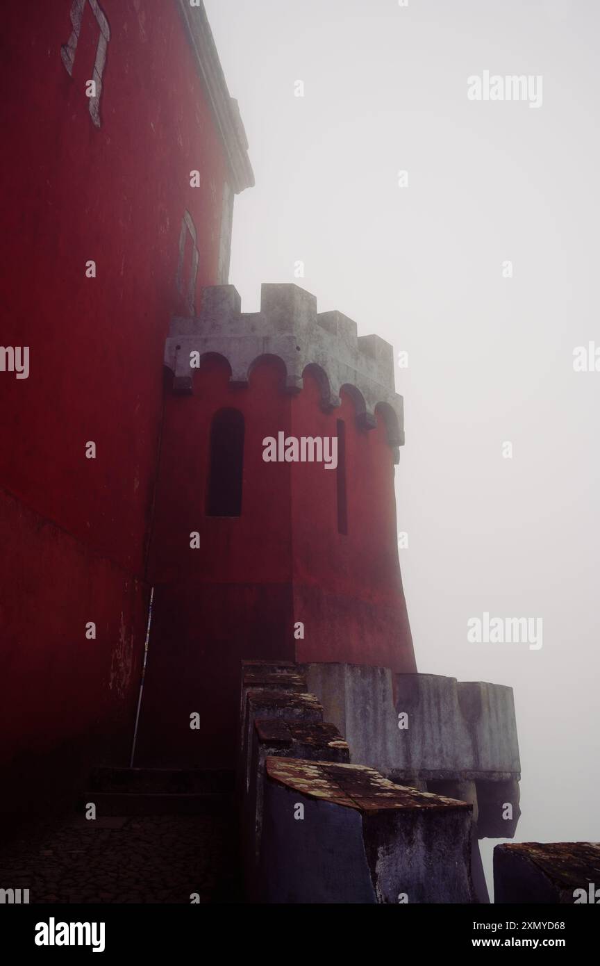 The weathered red walls of a turret at Pena Palace stand against the ...