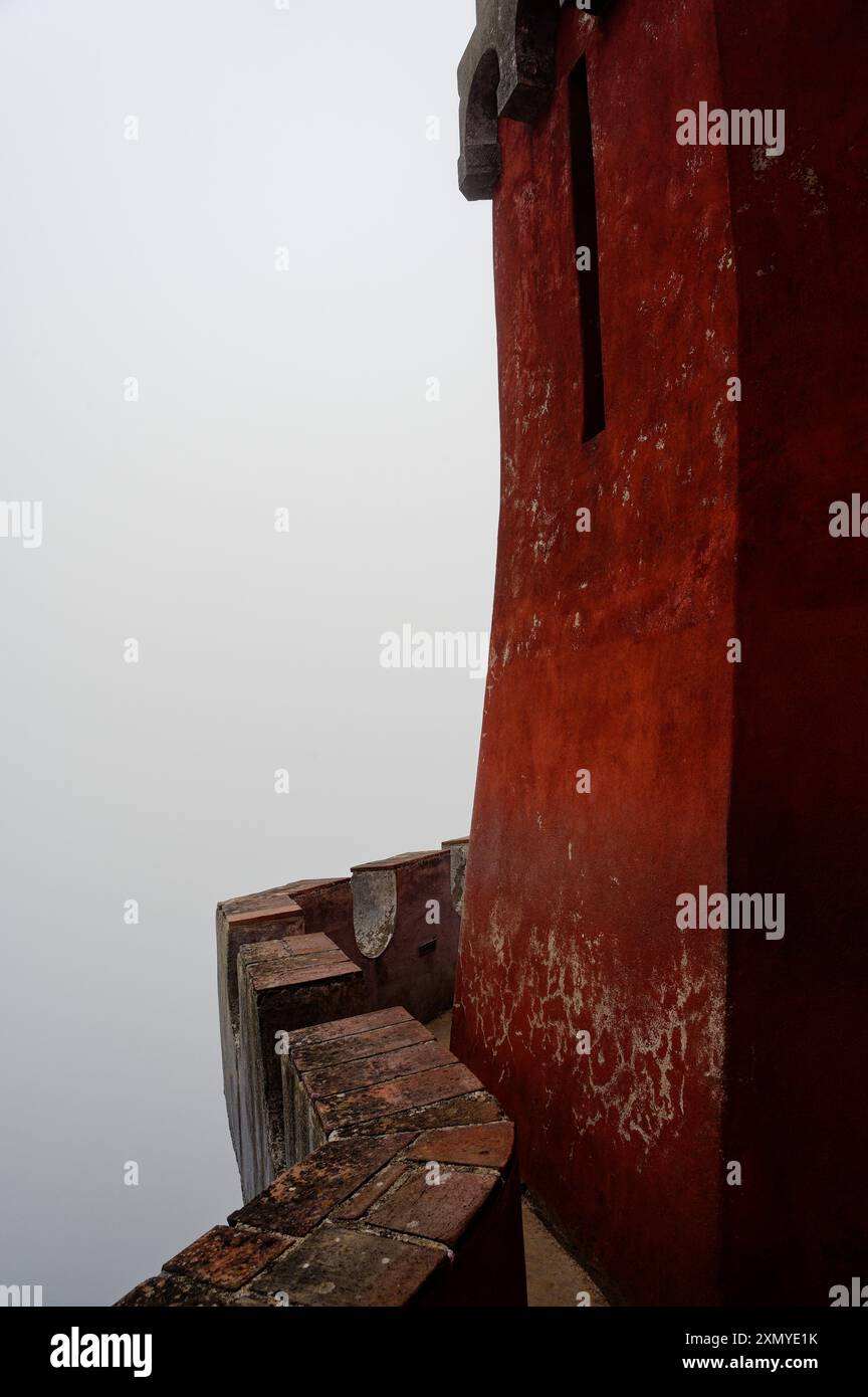The weathered red walls of a turret at Pena Palace stand against the ...