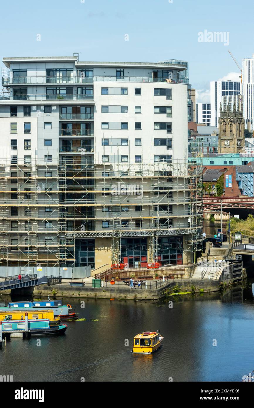 The yellow Leeds Dock water taxi on the water in front of Magellan ...