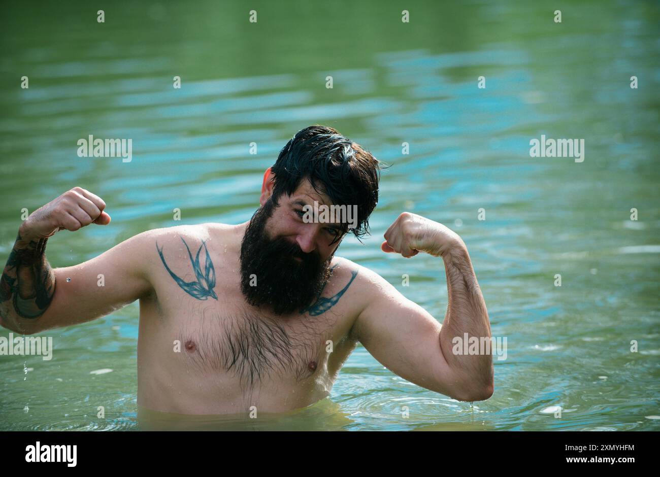 Bearded man on summer holidays. Male swimming in water. Having fun ...