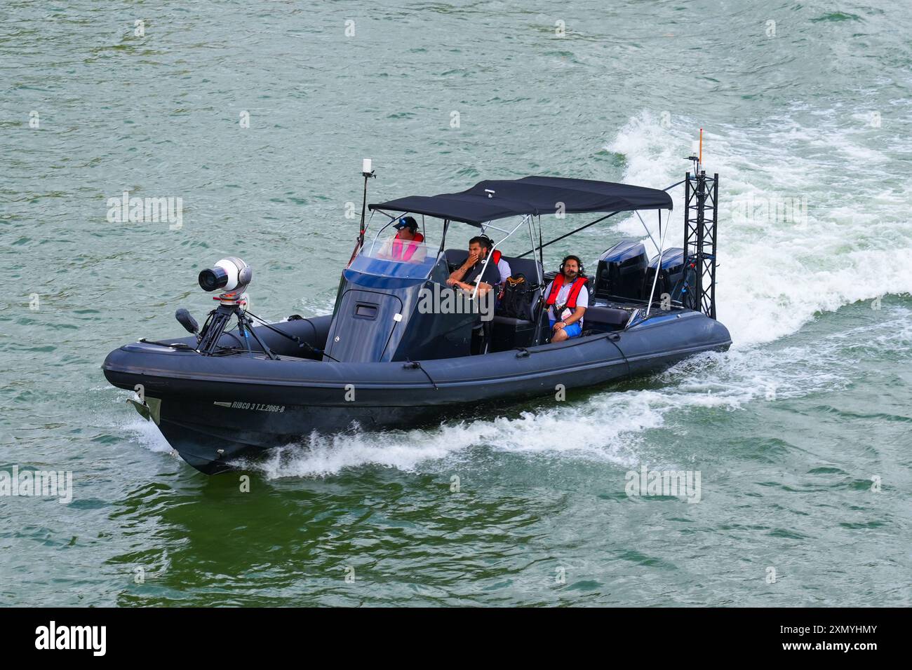 Film crew on an inflatable dinghy navigating on the Seine river ...