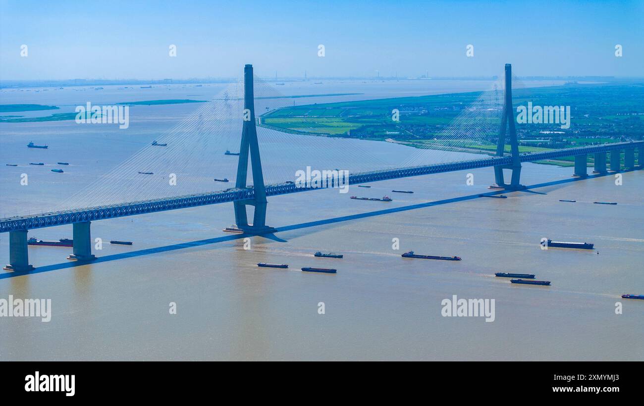 NANTONG, CHINA - JULY 29, 2024 - Cargo ships cross the Tongzhou section ...