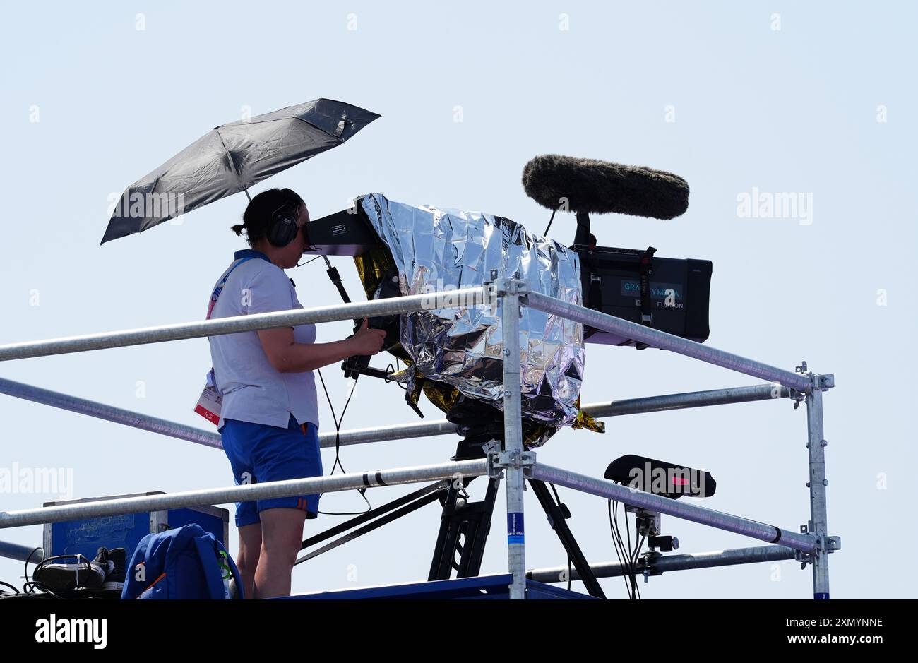 A camera operator shelters from the sun during the Women's Park ...