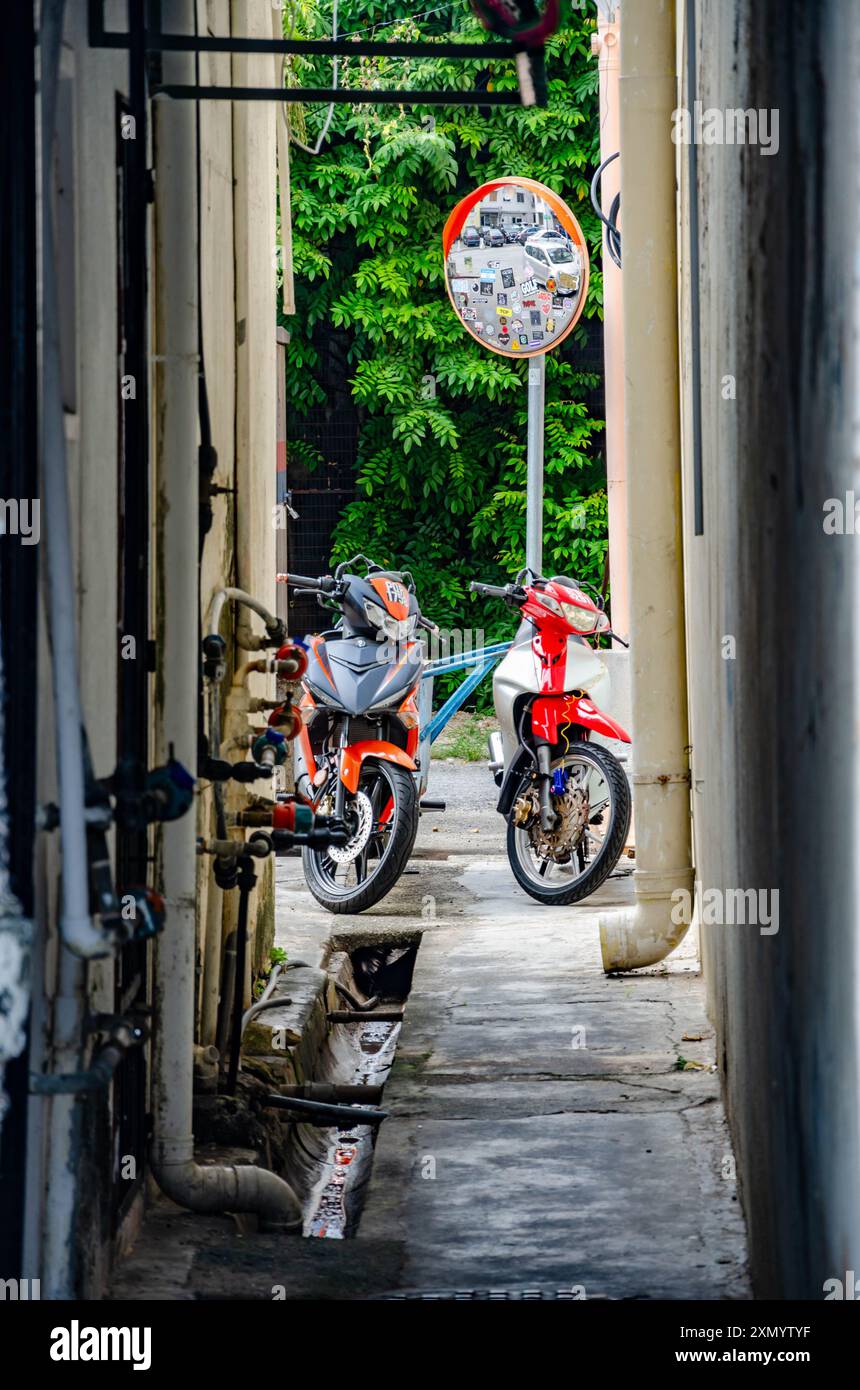 A dark alleyway in George Town, Penang, Malaysia with drain pipes ...