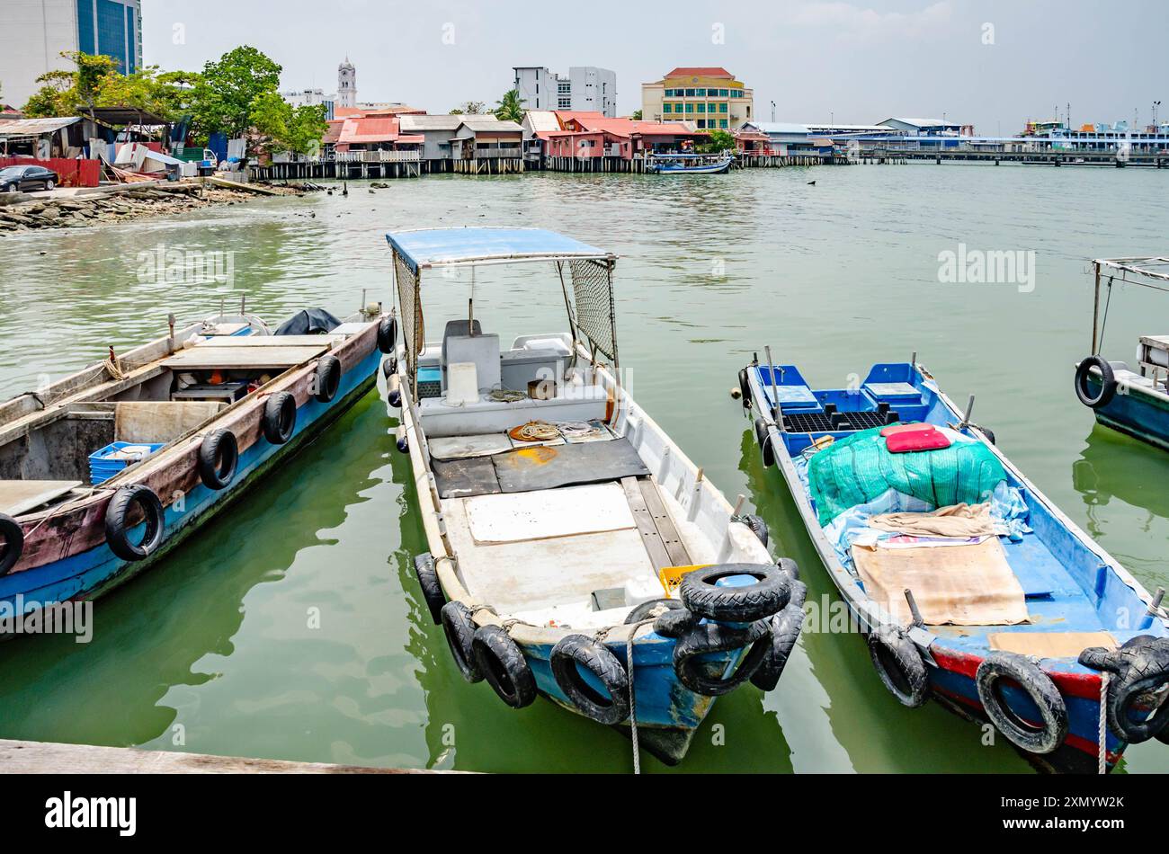 Boats floating on the sea, moored to the edge of The Chew Jetty in ...