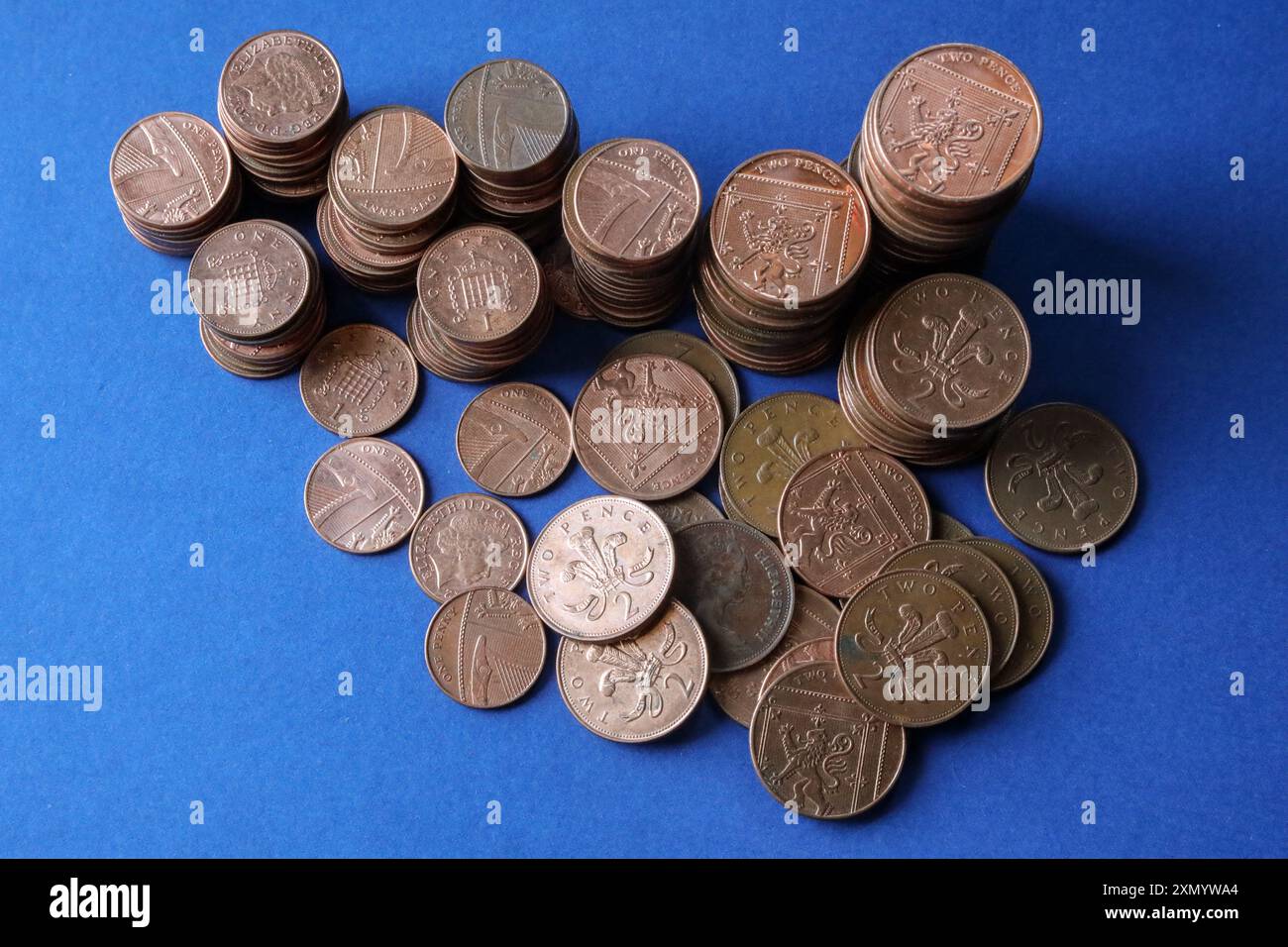 British low value penny coins on a blue background with 1p, 2p coins ...