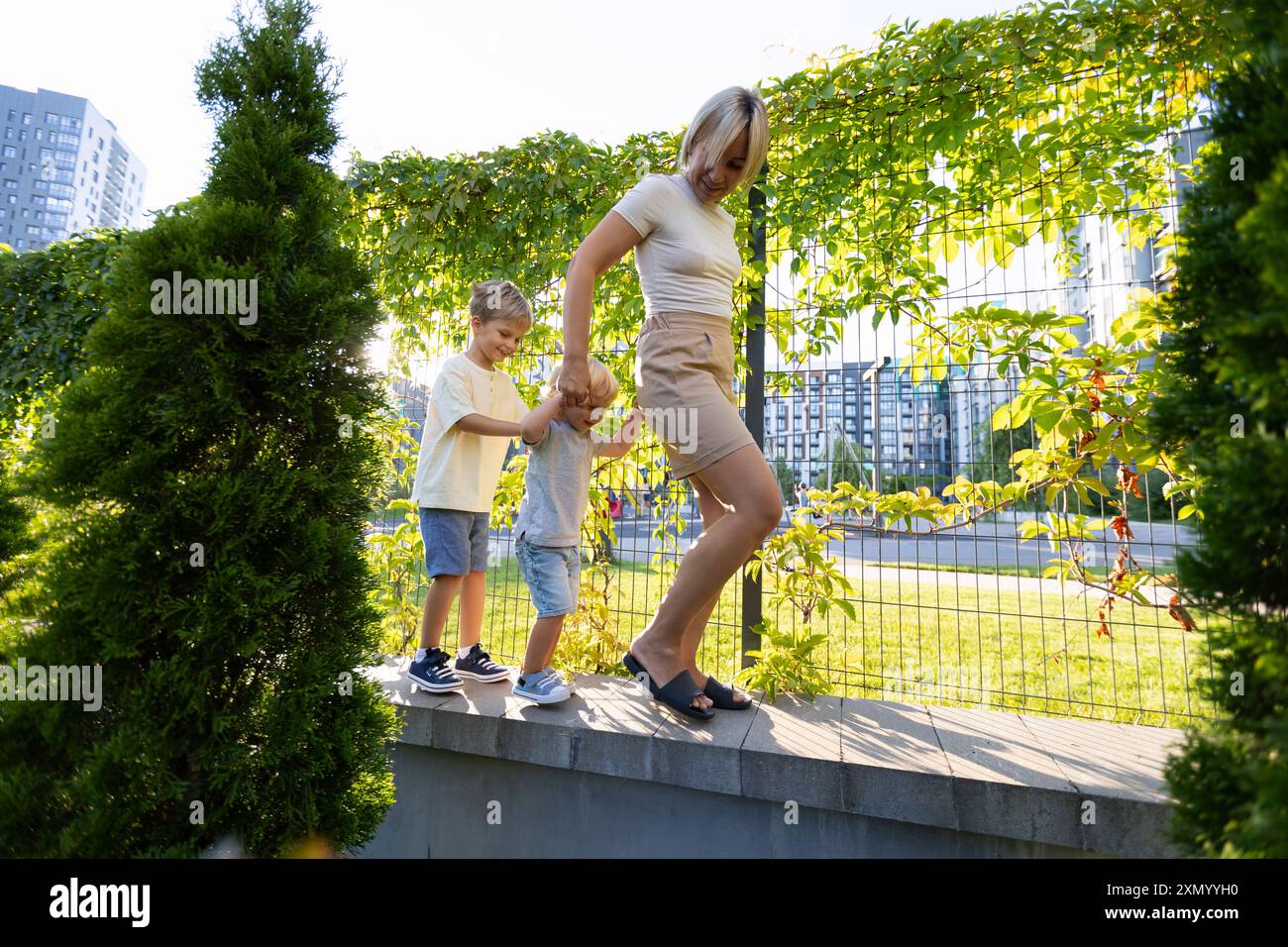 Mother Enjoys Fun Outdoor Playtime With Her Two Sons at the Local ...