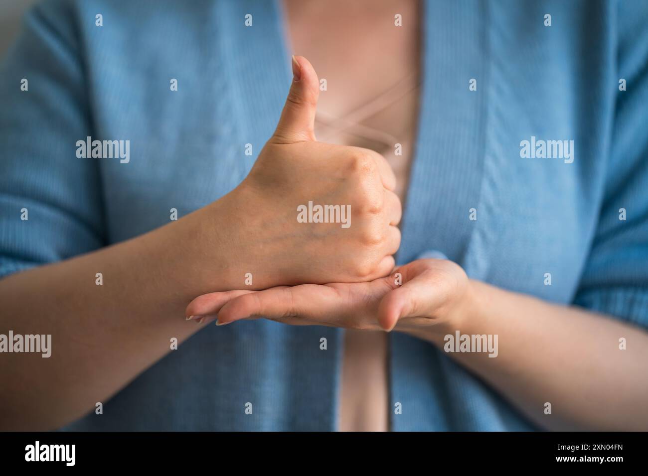 Hand showing thumbs up gesture in sign language, representing approval ...
