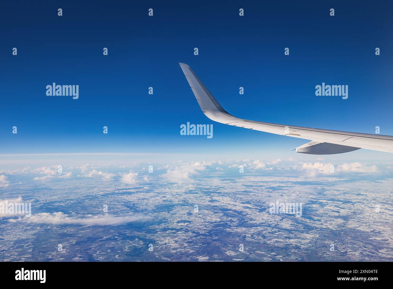 Airplane flying over color sky clouds during scenic sunset or sunrise ...
