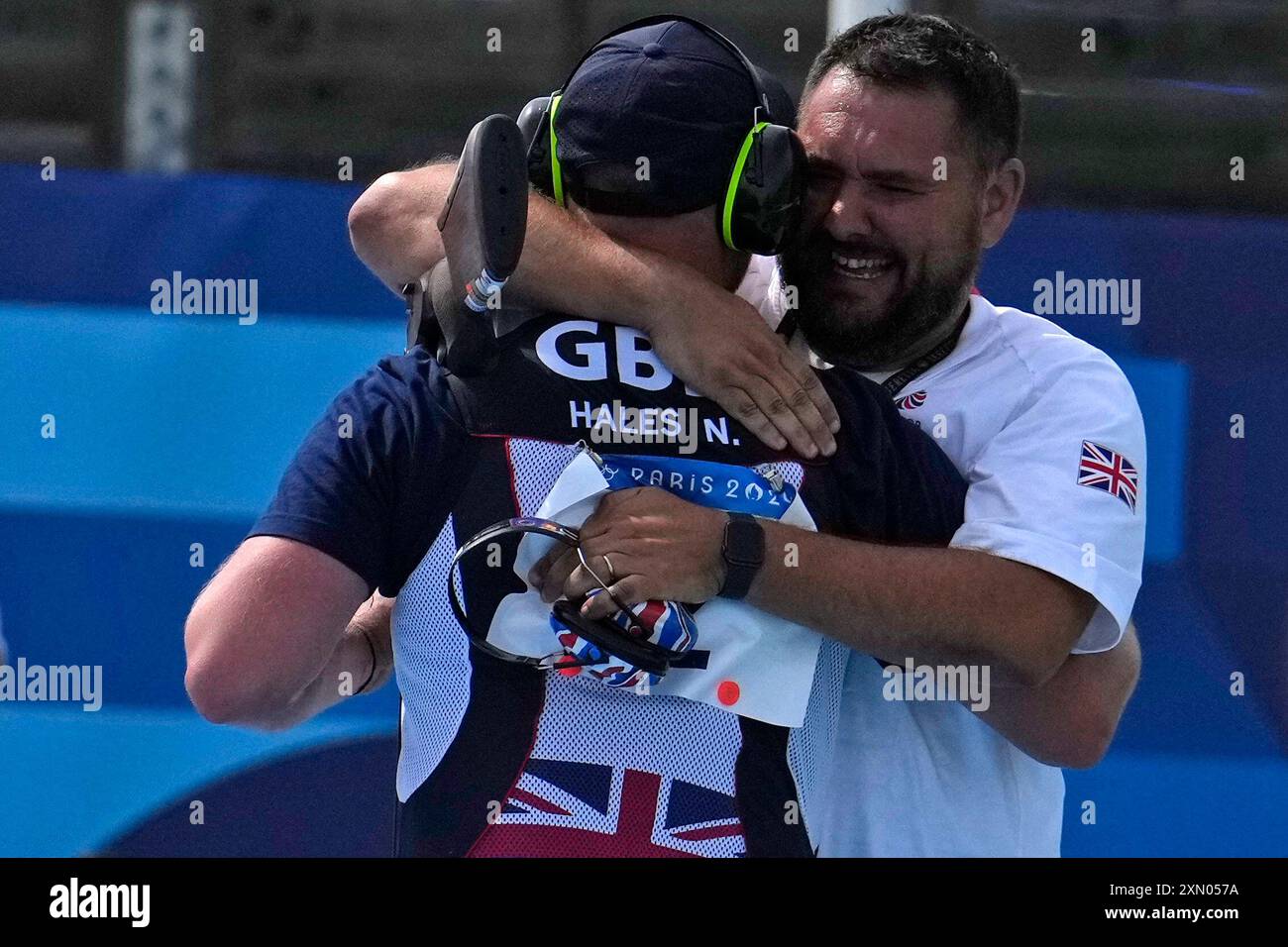 Britain's Nathan Hales receives a hug from his coach after winning the ...