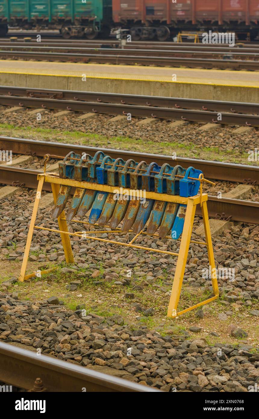 The brake shoe is on the rail under the wheel of the wagon with a ...