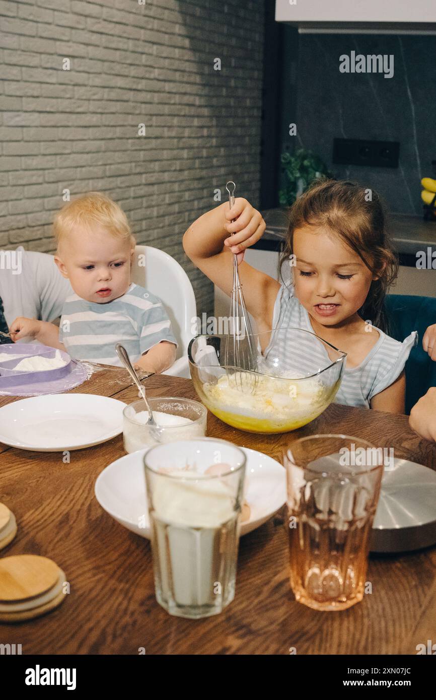 Children joyfully cooking together in a warm and inviting kitchen ...