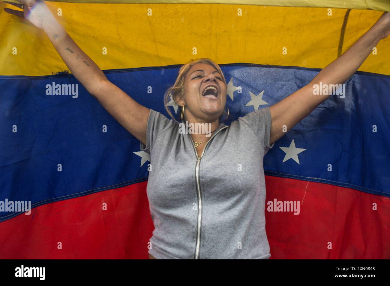 A woman celebrates outside the Miraflores Palace for the re-election of ...