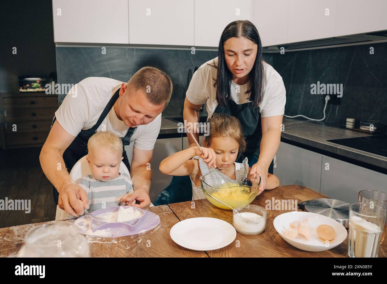 A family enjoys the joyful experience of cooking together in a ...