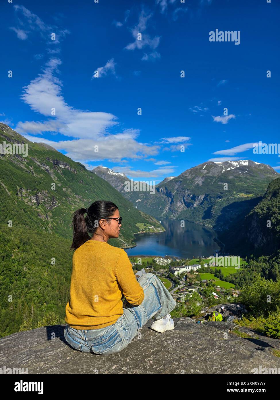 A peaceful moment in Norway, where a young woman gazes at stunning ...