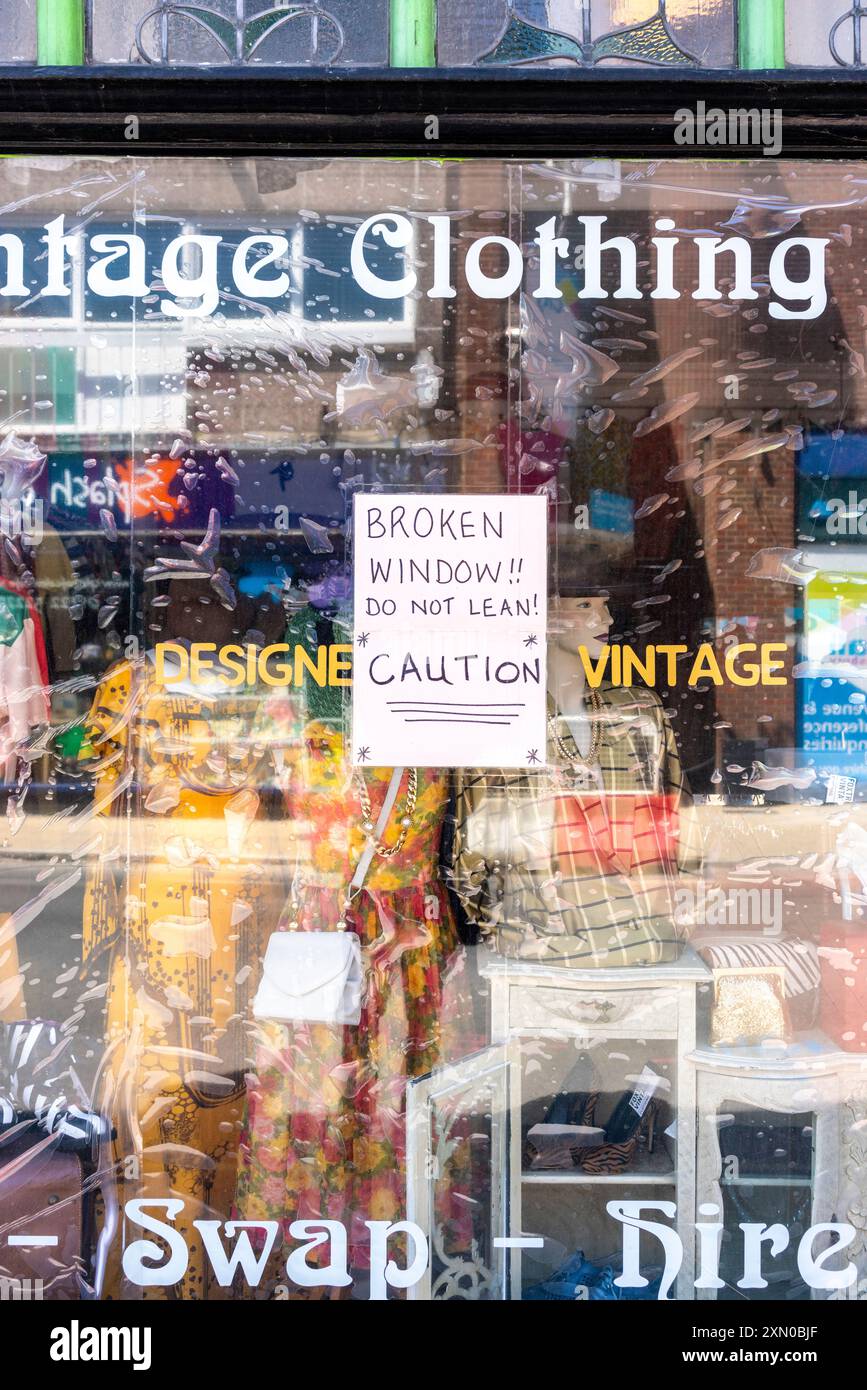 Broken shop window covered by polythene safety film and sign Stock ...