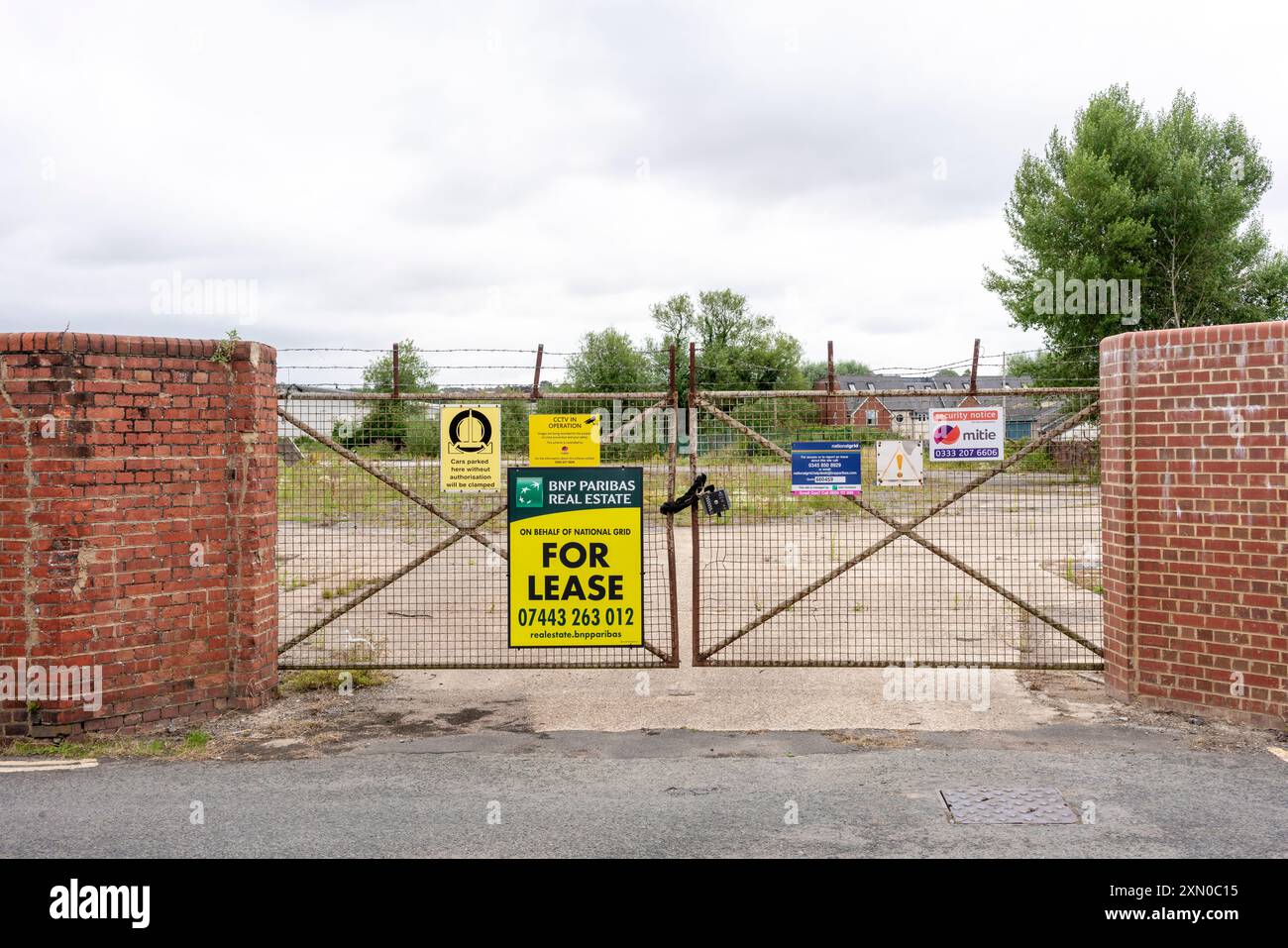 Development land for lease behind locked gates Stock Photo - Alamy