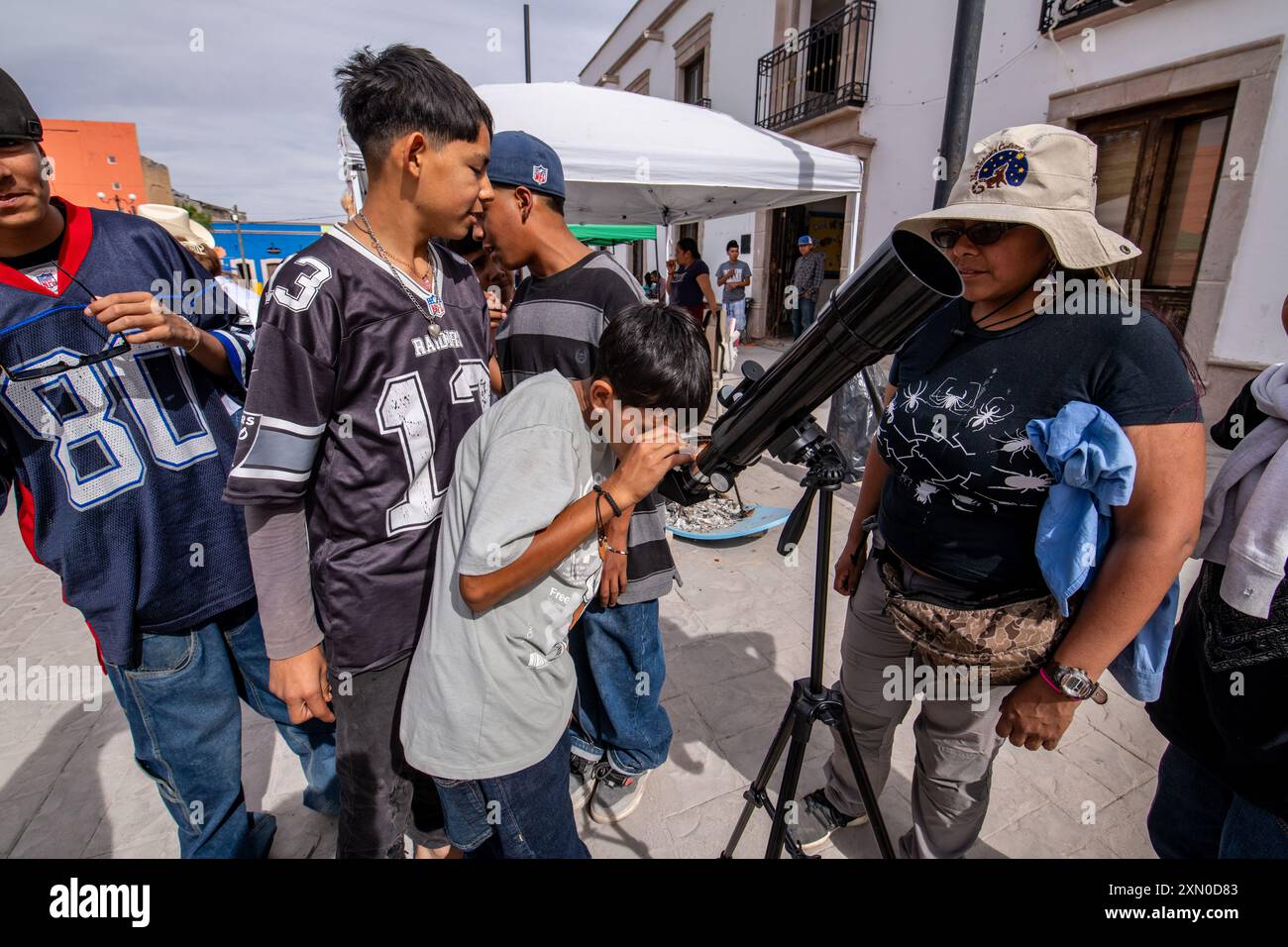 Community looking through telescope for the 2024 eclipse in Mapimi ...