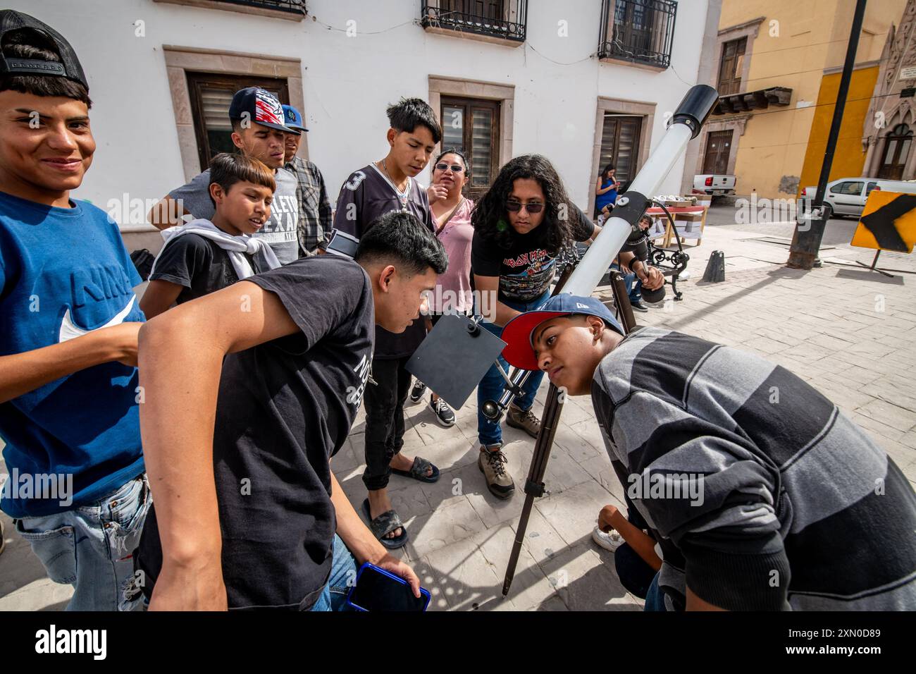 Community looking through telescope for the 2024 eclipse in Mapimi ...