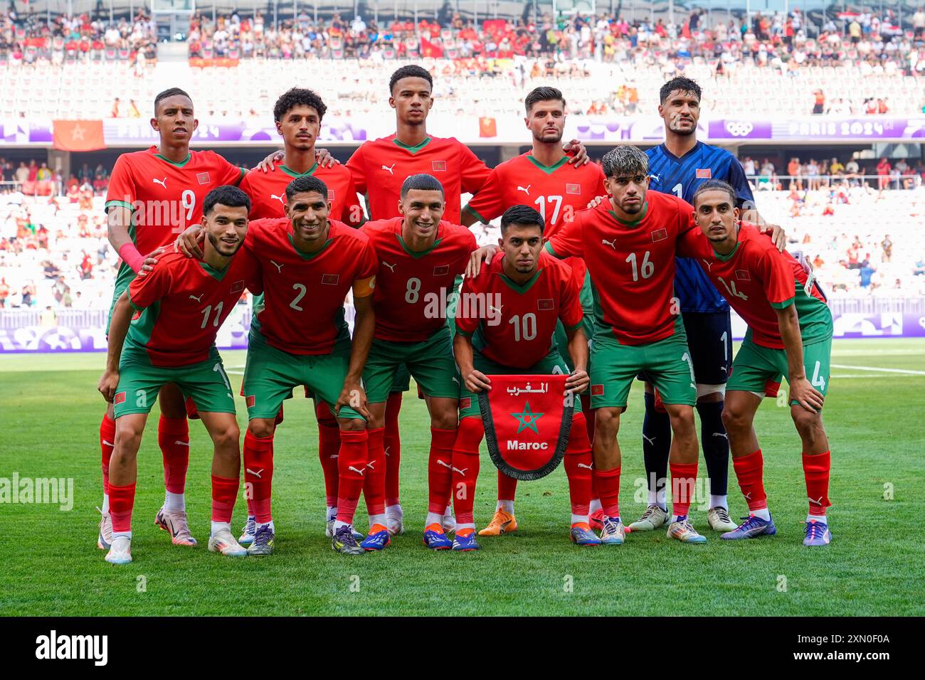 Morocco athletes pose for photographers prior to a men's Group B soccer ...