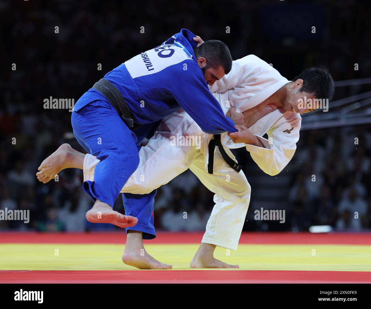 Japan's NAGASE Takanori(white) and Georgia's GRIGALASHVILI Tato compete during the men's judo ...