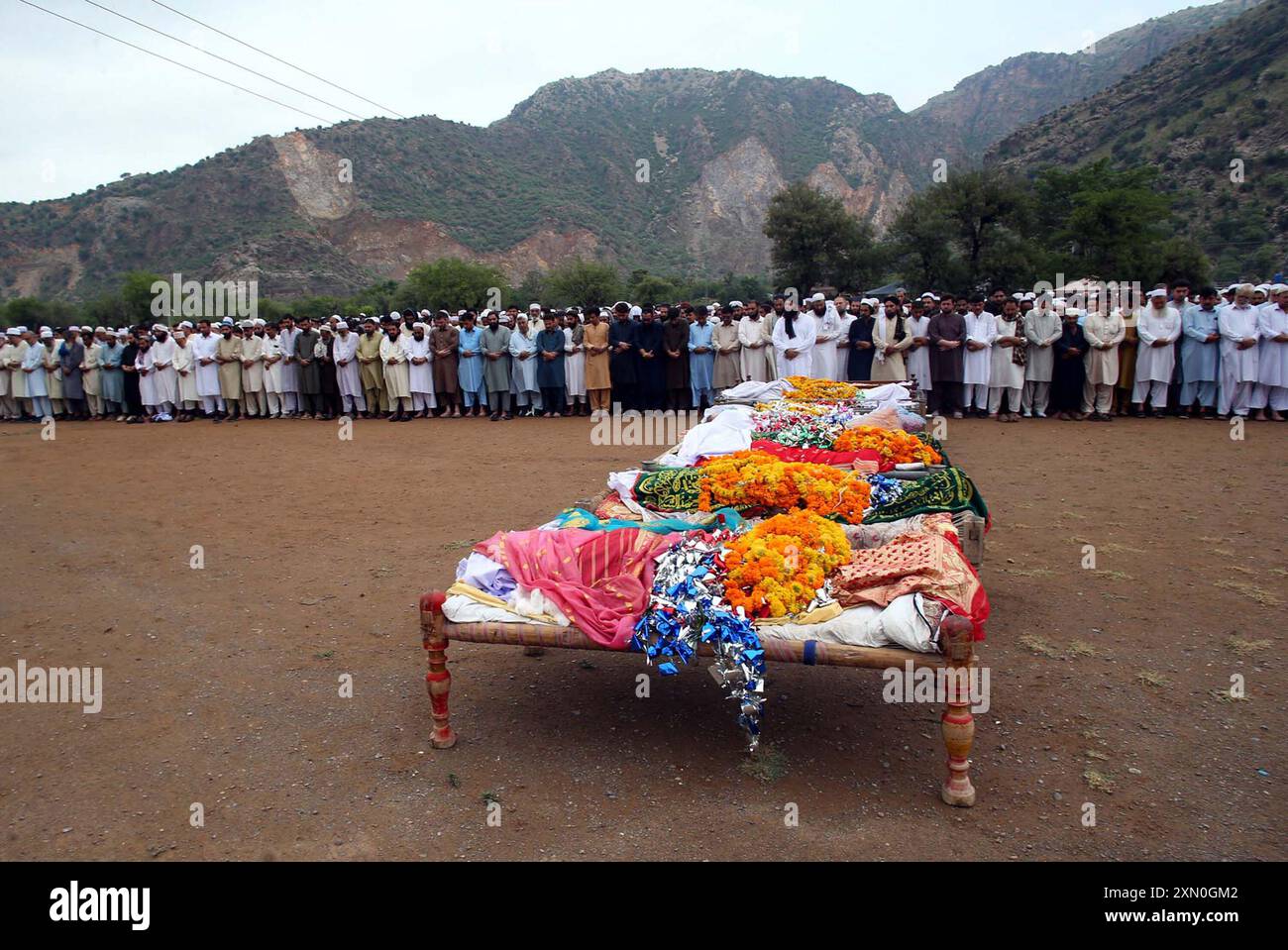 People are offering funeral prayer of a family members, who died due to ...