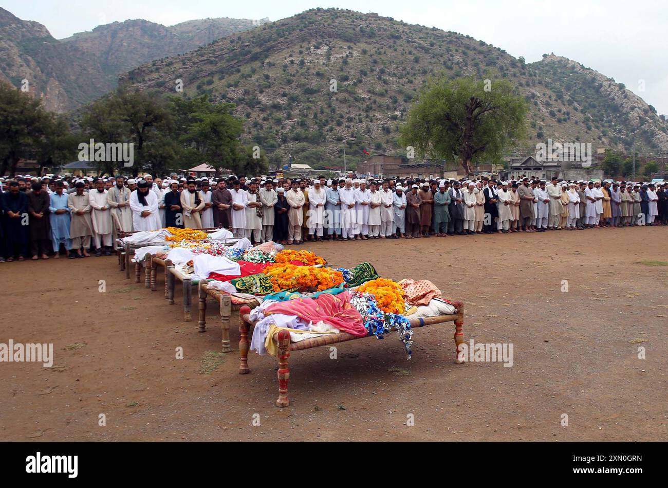 People are offering funeral prayer of a family members, who died due to ...