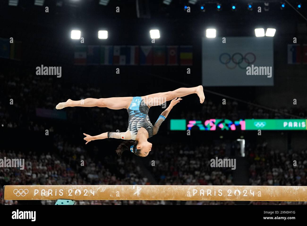 Mana Okamura, of Japan, performs on the balance beam during the women's ...