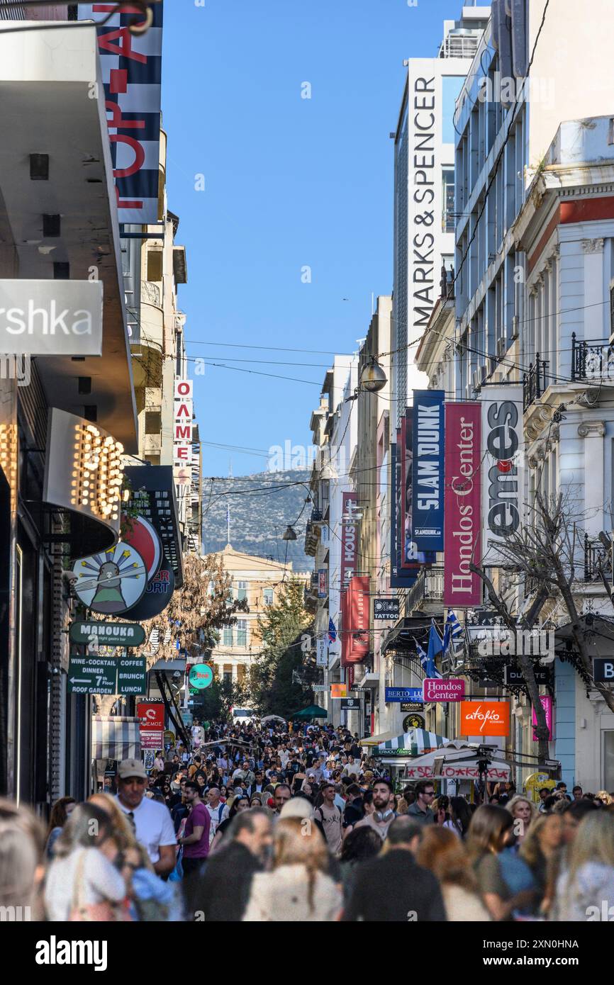 Crowds of people and shops on Ermou street in the center of Athens ...
