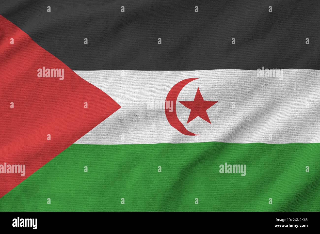 Western Sahara flag depicted on folded wavy fabric of old cloth close ...