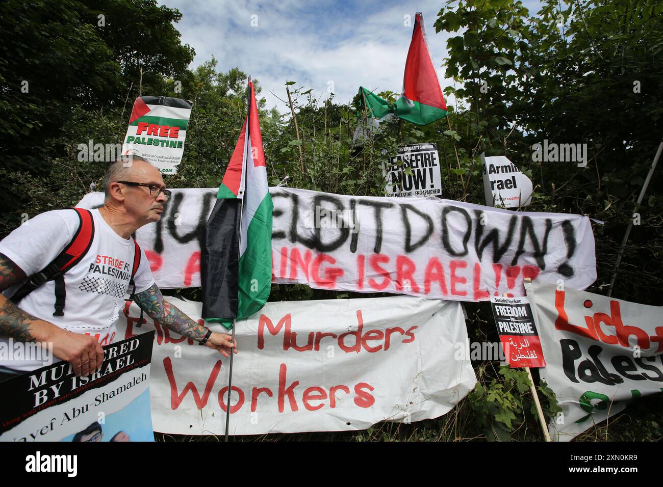 July 30, 2024, Shenstone, England, UK: A protester grabs a flag from an ...