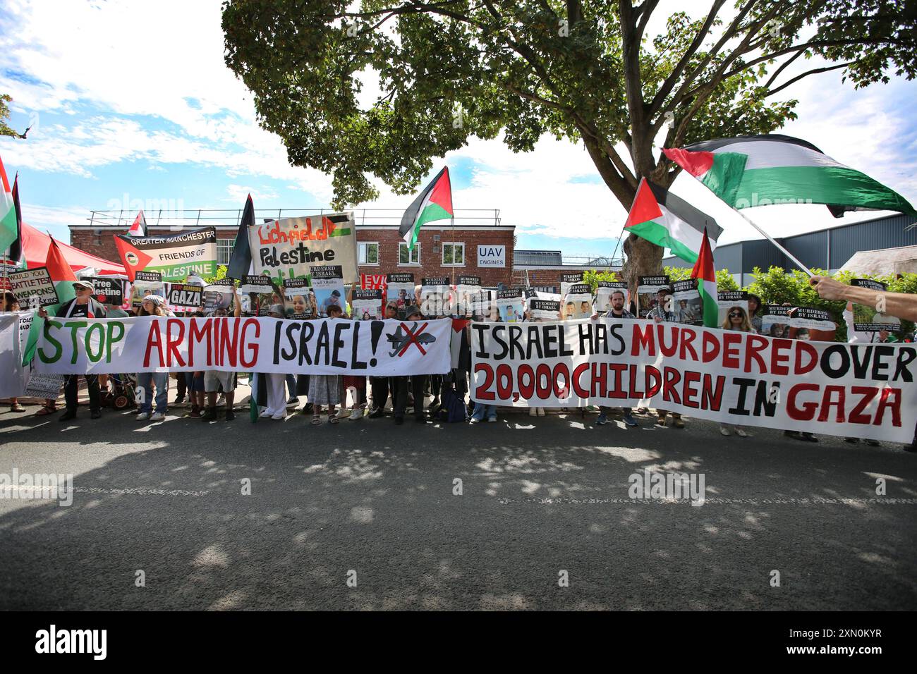 Shenstone, England, UK. 30th July, 2024. Protesters hold up signs and ...