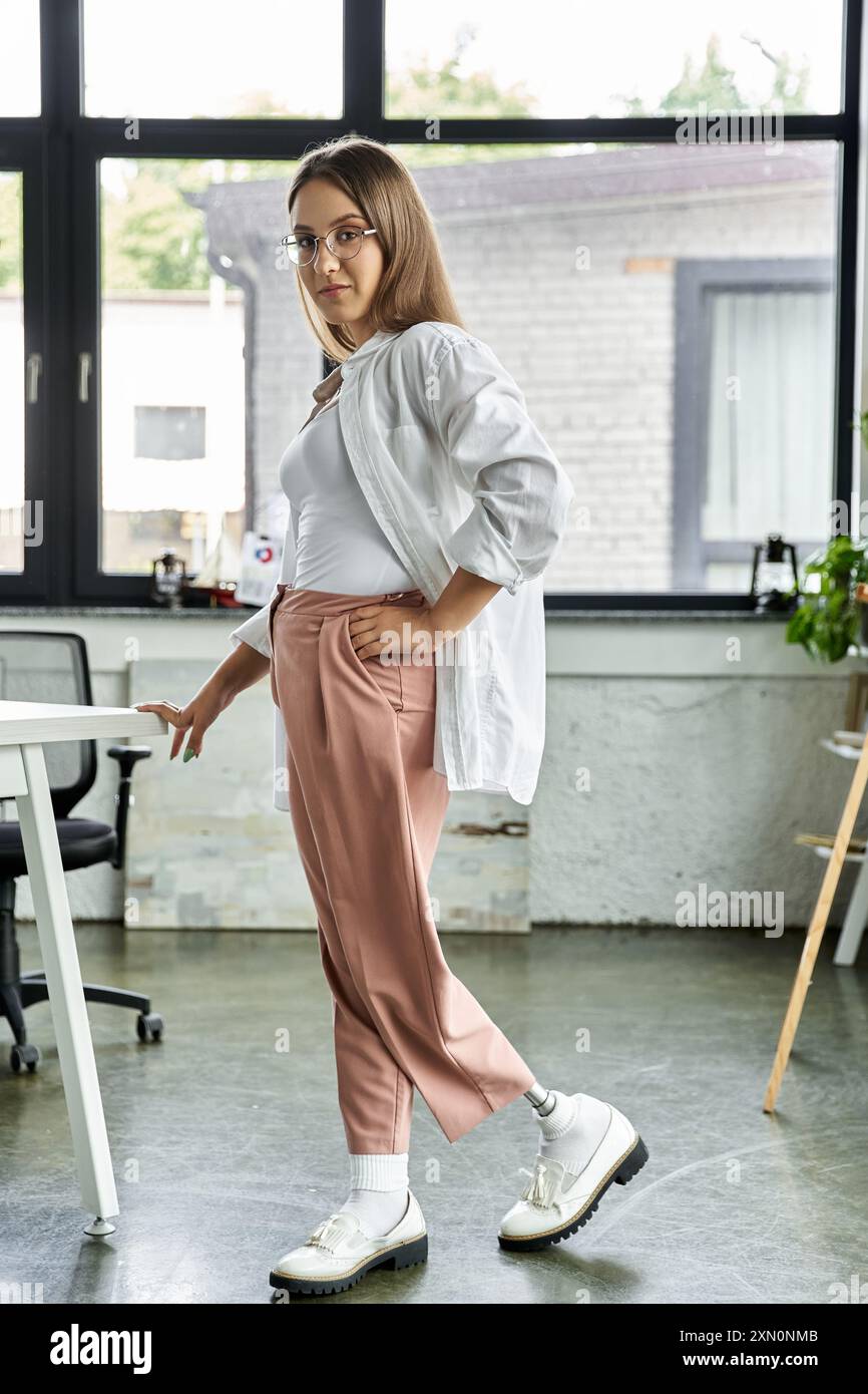 A woman with a prosthetic leg stands in an office, confidently looking ...